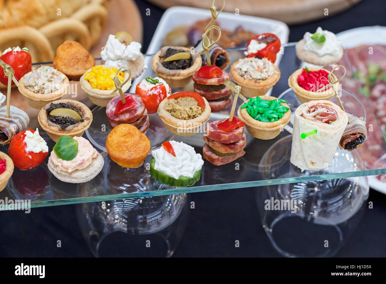 types of canapes for cocktails on a glass plate, note shallow depth of ...
