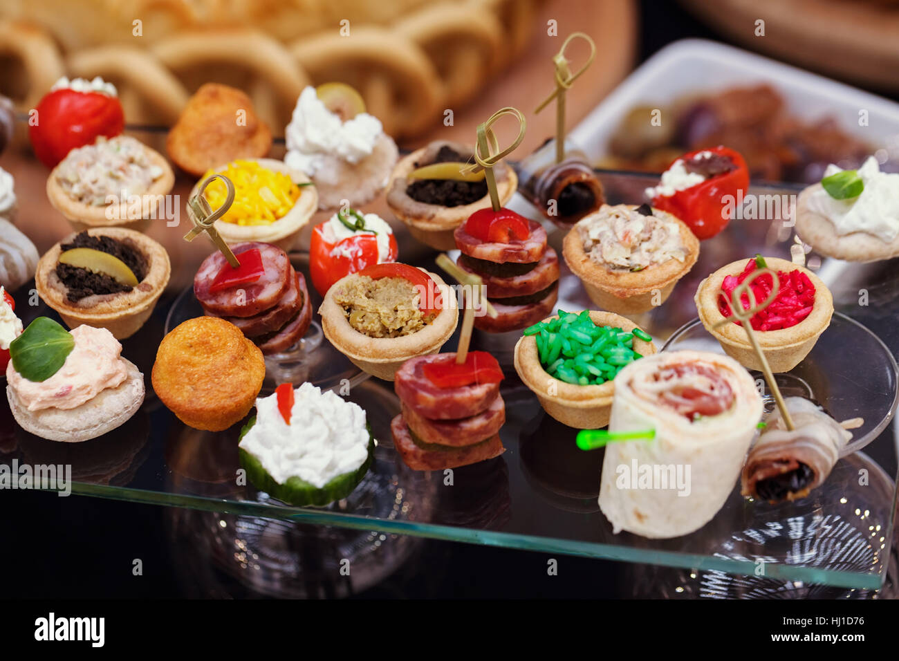 types of canapes for cocktails on a glass plate, note shallow depth of ...