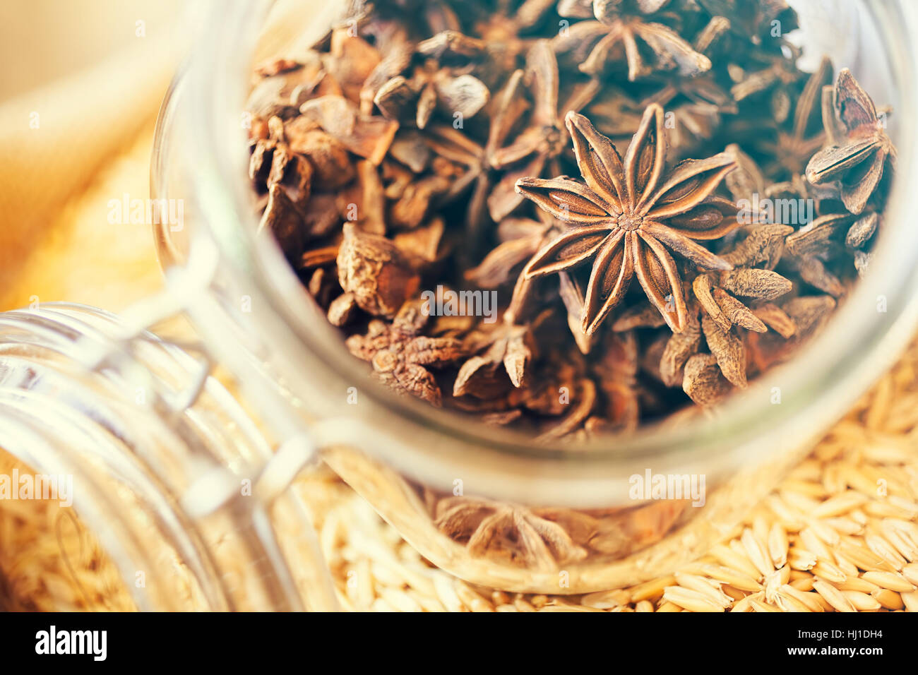 anise flowers in a glass jar on a pile of grain, note shallow depth of ...