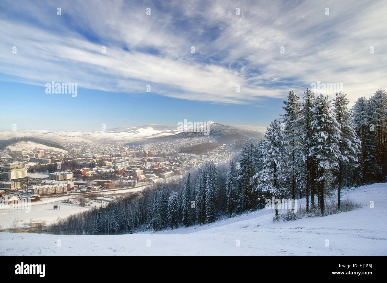 Winter snowy mountain valley with village town and slope with frozen ...