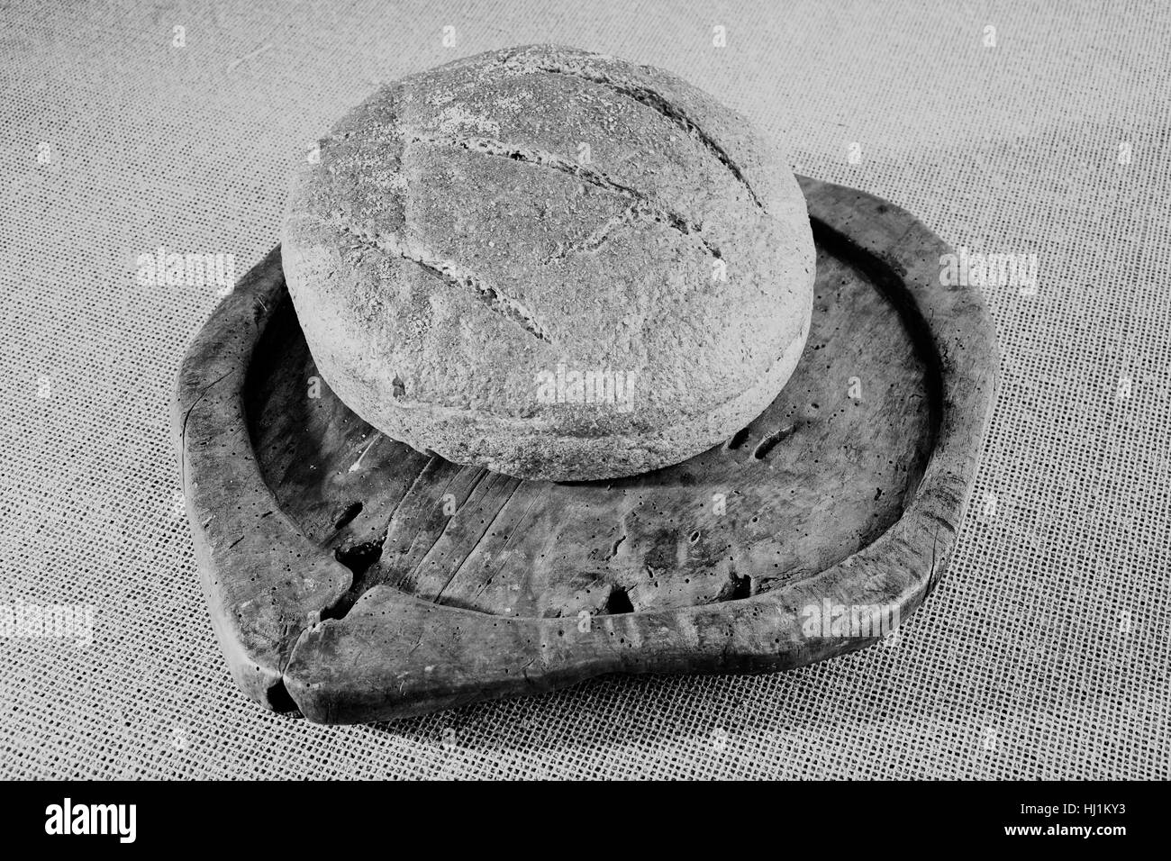 round integral bread on the wood board, note shallow depth of field ...