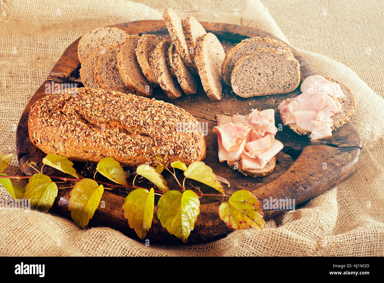 integral bread on the wood board with ham and green branch, note ...