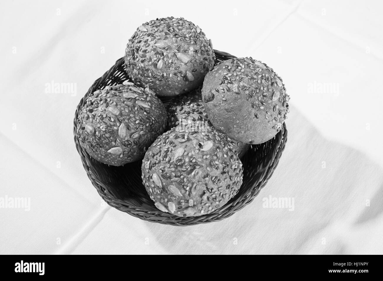 a small round bread with seeds in a wicker basket Stock Photo - Alamy