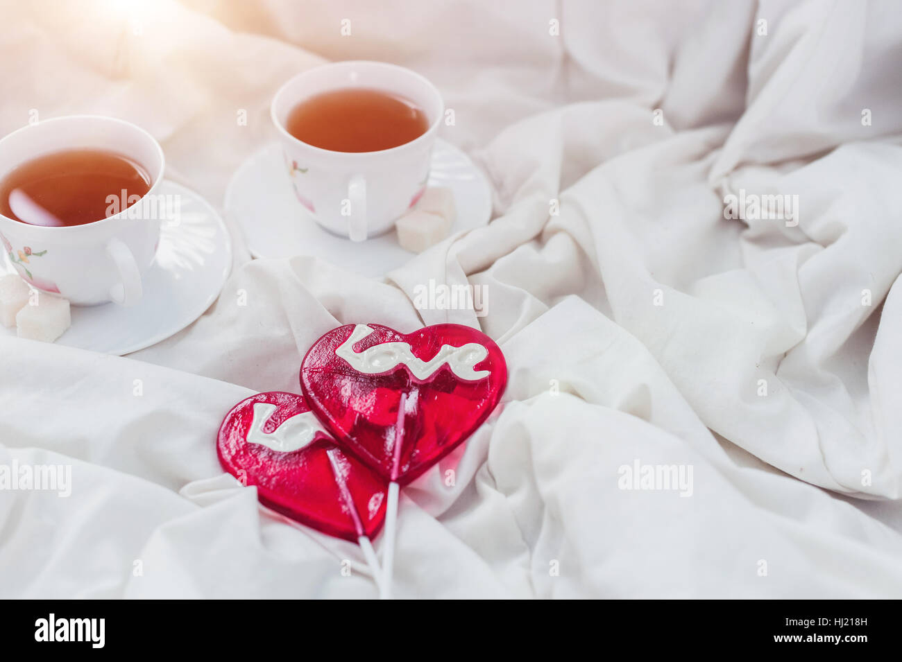 Breakfast in bed in Valentines day. Cup of tea and sweet candies. Love ...