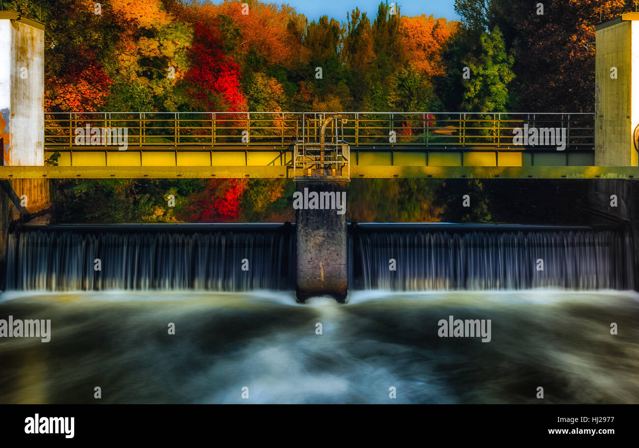 Color outdoor image of a river dam waterfall, autumn, fall, tree,red ...