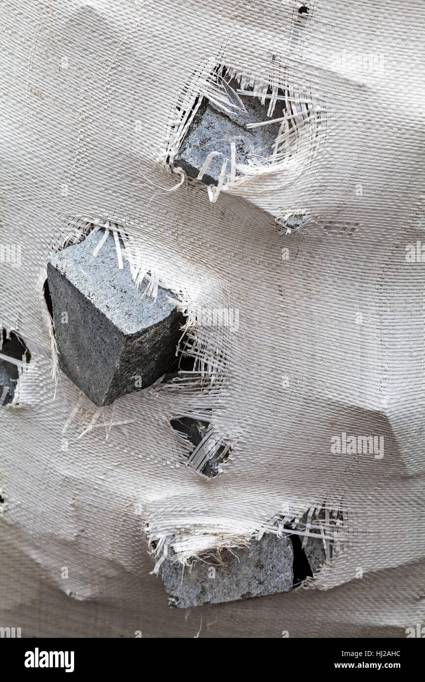granite cubes in a torn plastic sack, note shallow depth of field Stock ...