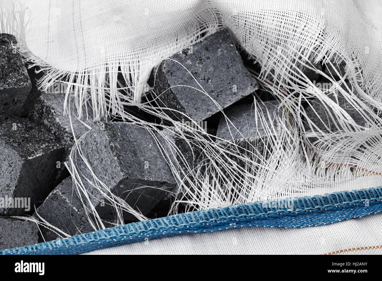 granite cubes in a torn plastic sack, note shallow depth of field Stock ...