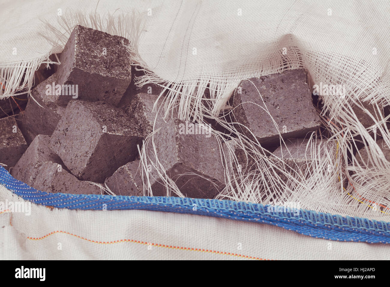 granite cubes in a torn plastic sack, note shallow depth of field Stock ...