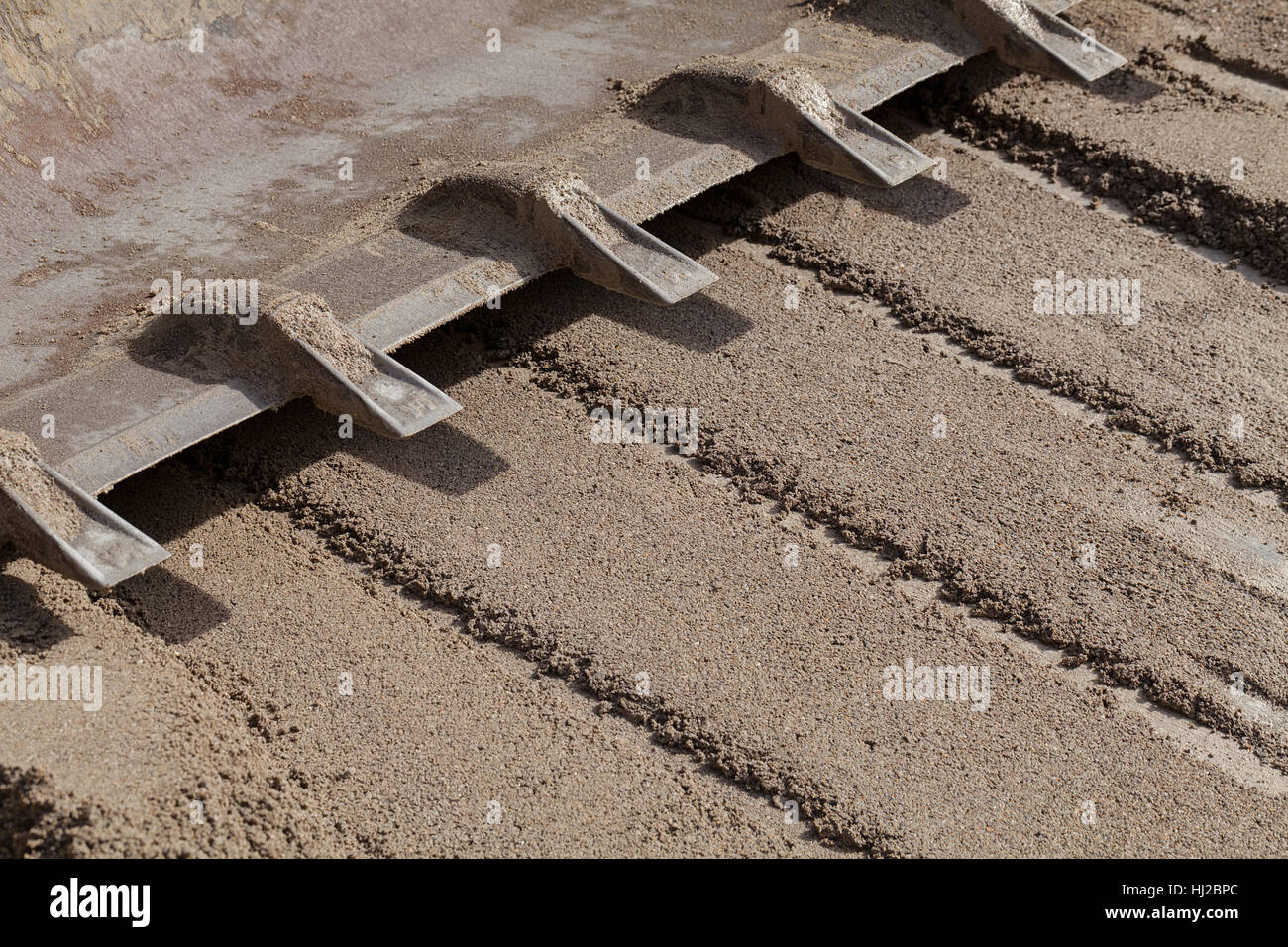 sand in construction with traces of buckets for loading on excavator ...