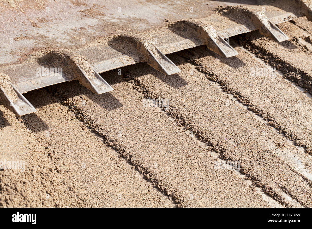 sand in construction with traces of buckets for loading on excavator ...
