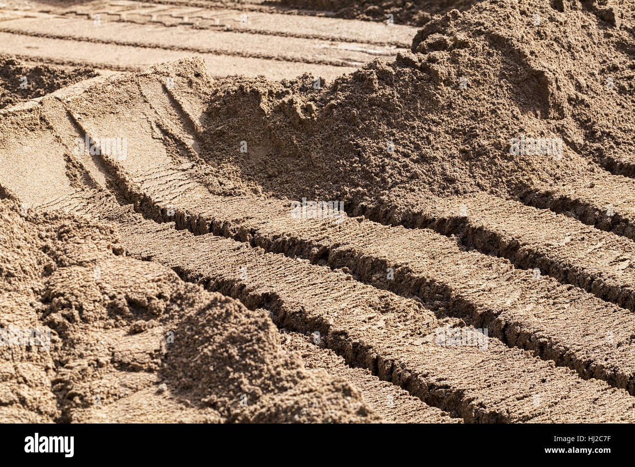 sand in construction with traces of buckets for loading on excavator ...