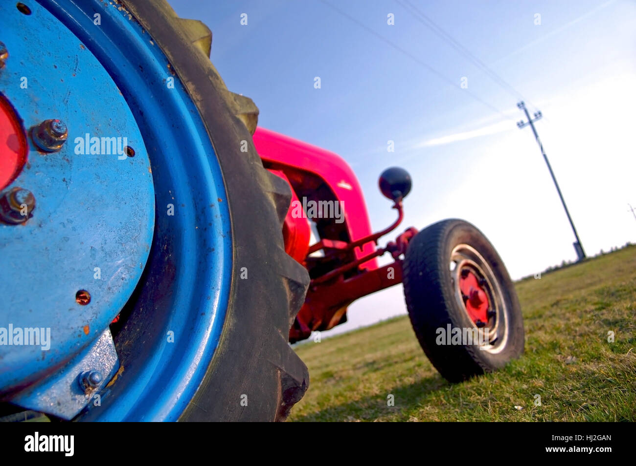Colorful tractor colored in red and blue Stock Photo - Alamy