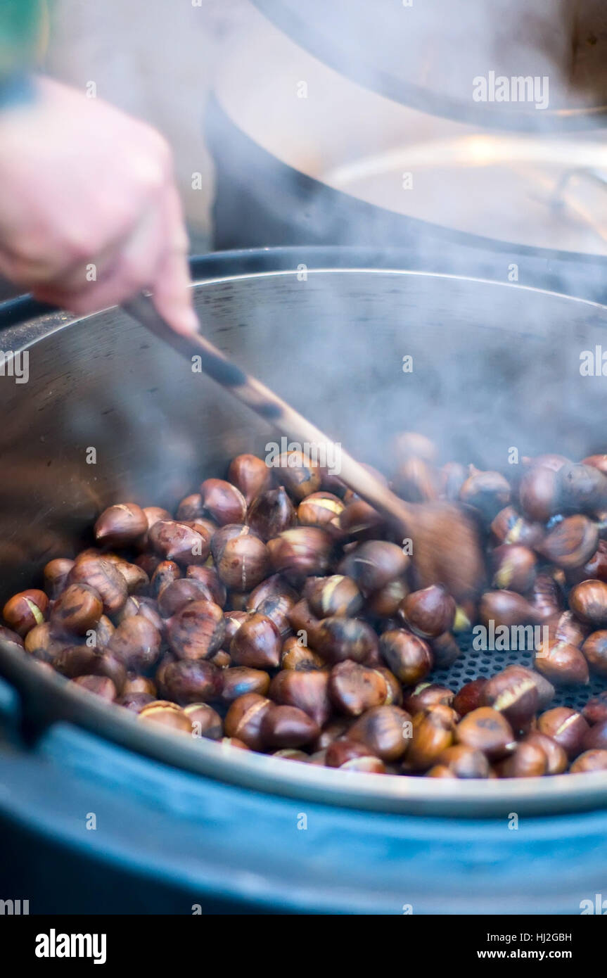 Person makes Roasted Chestnut in a big Pot Stock Photo - Alamy