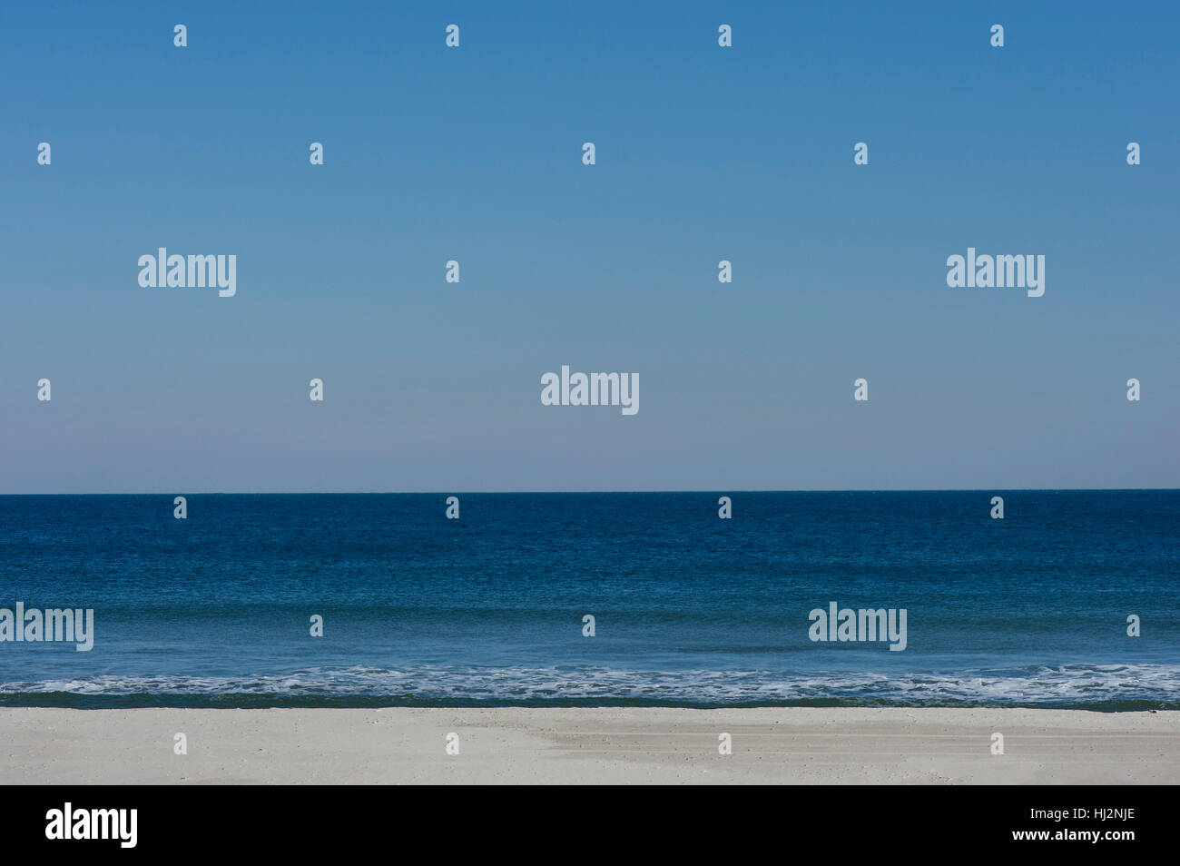 A view of the beach with a clear blue sky over the Atlantic Ocean Stock ...