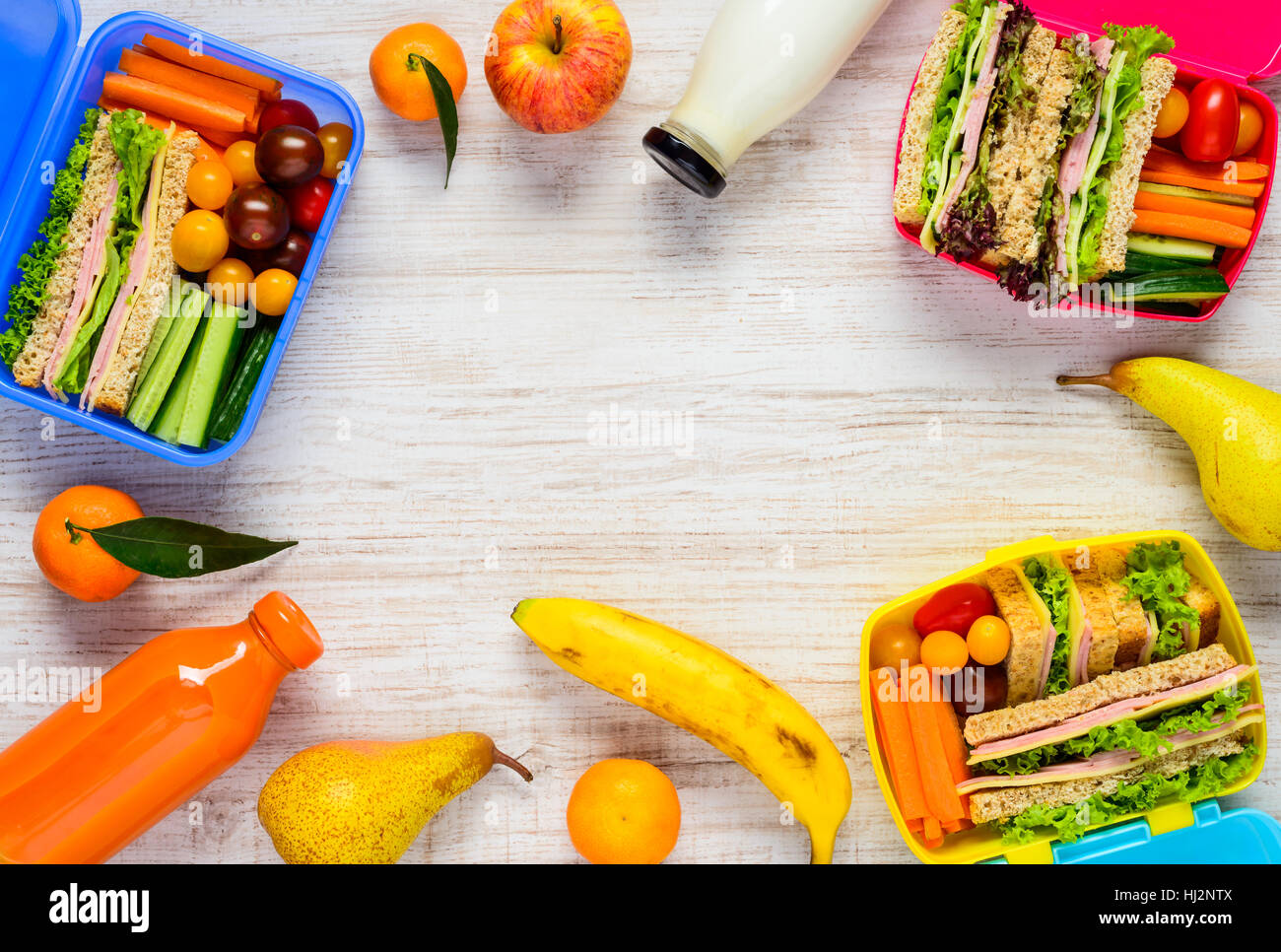 Copy Space Frame of Lunch Boxes with Fruits and Drinks Stock Photo - Alamy