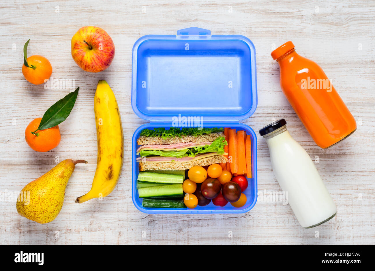 Blue Lunch Box with Sandwiches, Vegetables, Fruits and a Bottle of Milk ...