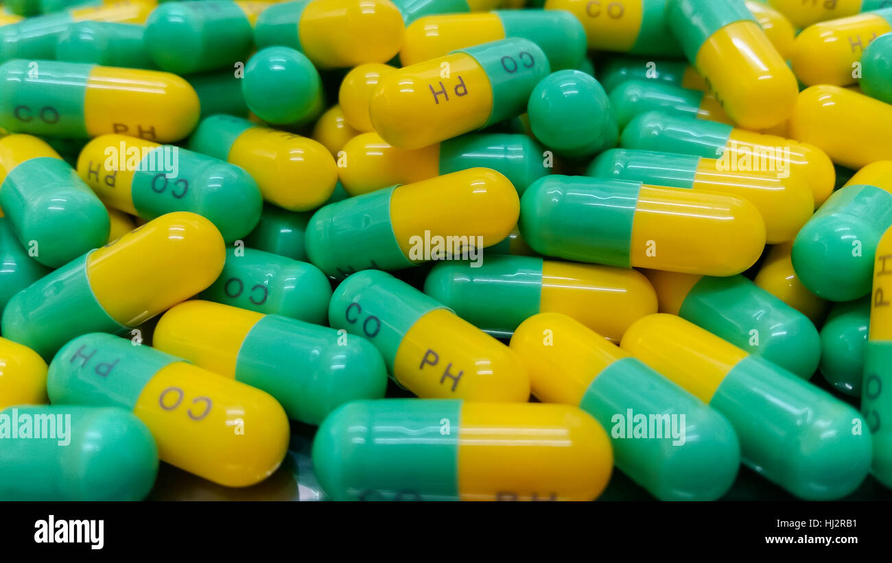 Two tone Medicine Capsules on Stainless Steel drug tray, Yellow Green ...