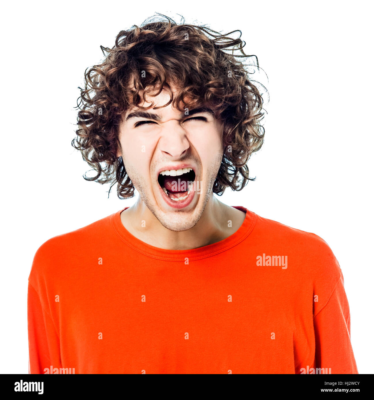 one young man caucasian screaming angry portrait in studio white ...