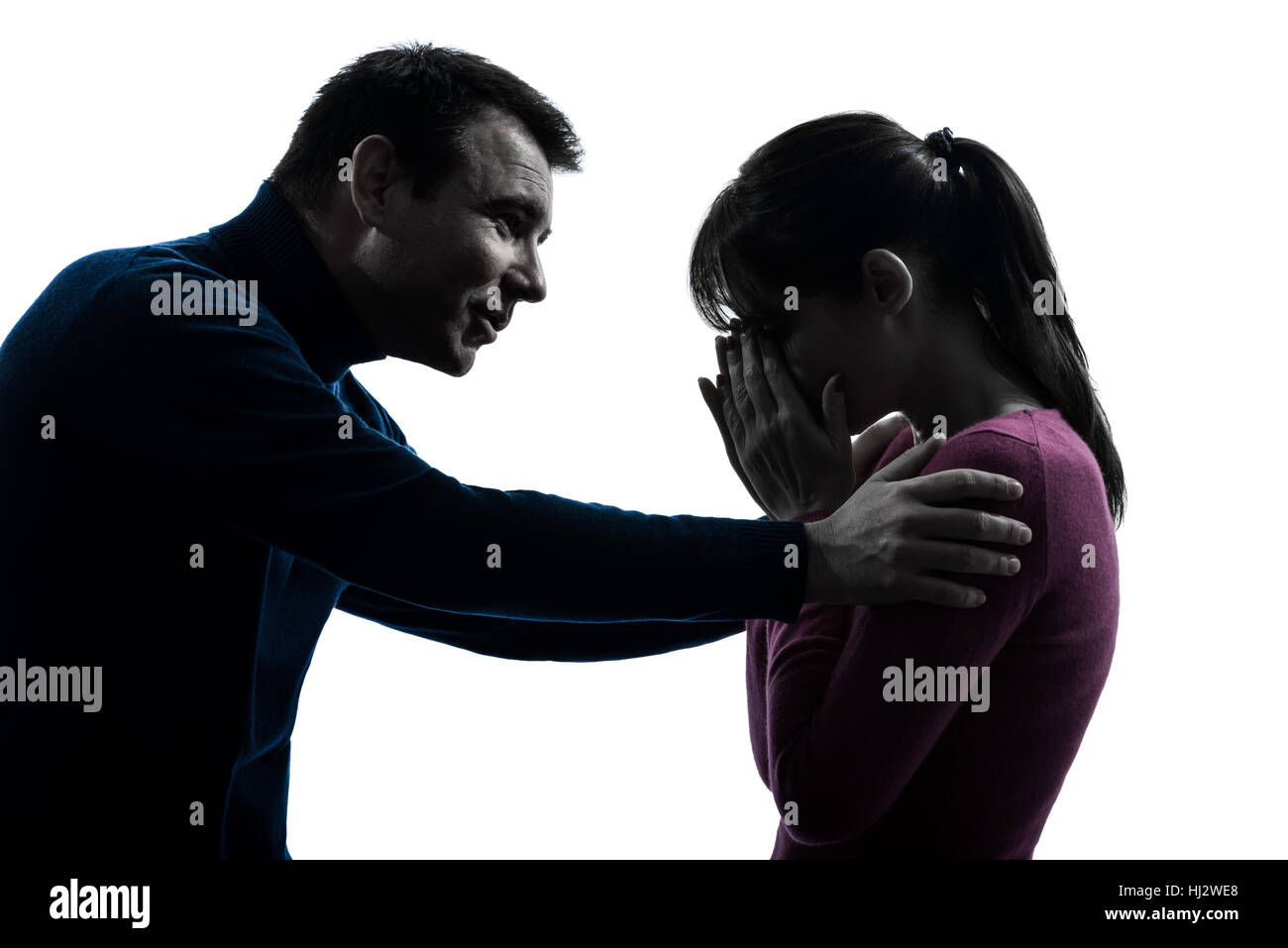 one caucasian couple woman crying man consoling in silhouette studio ...