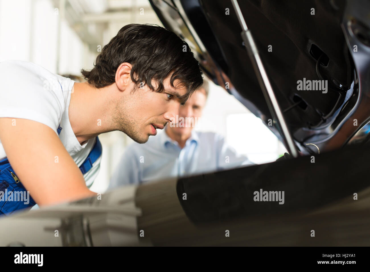 customer and mechanic at car look under the hood Stock Photo - Alamy