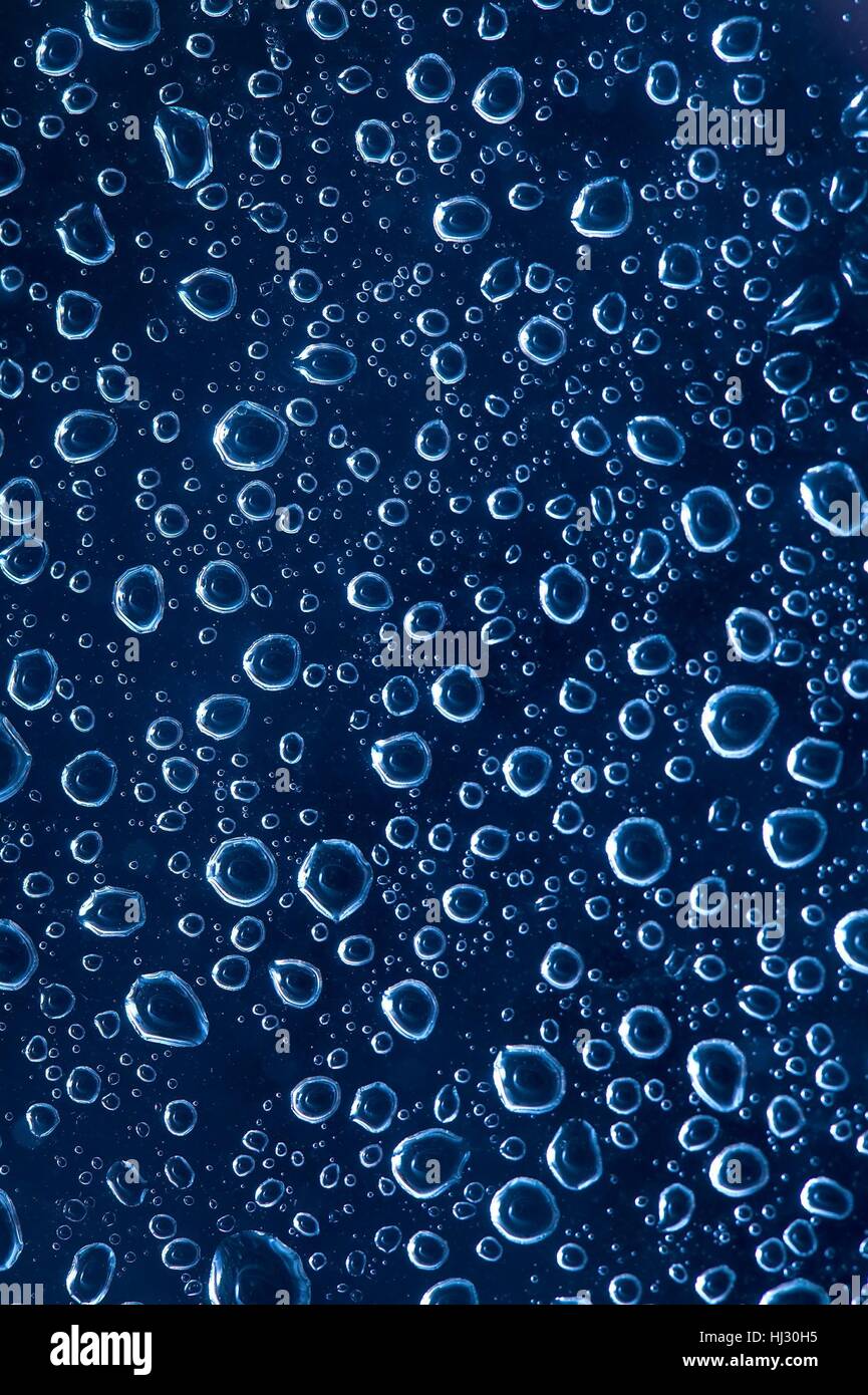 Shiny water drops over darker surfaces Stock Photo - Alamy