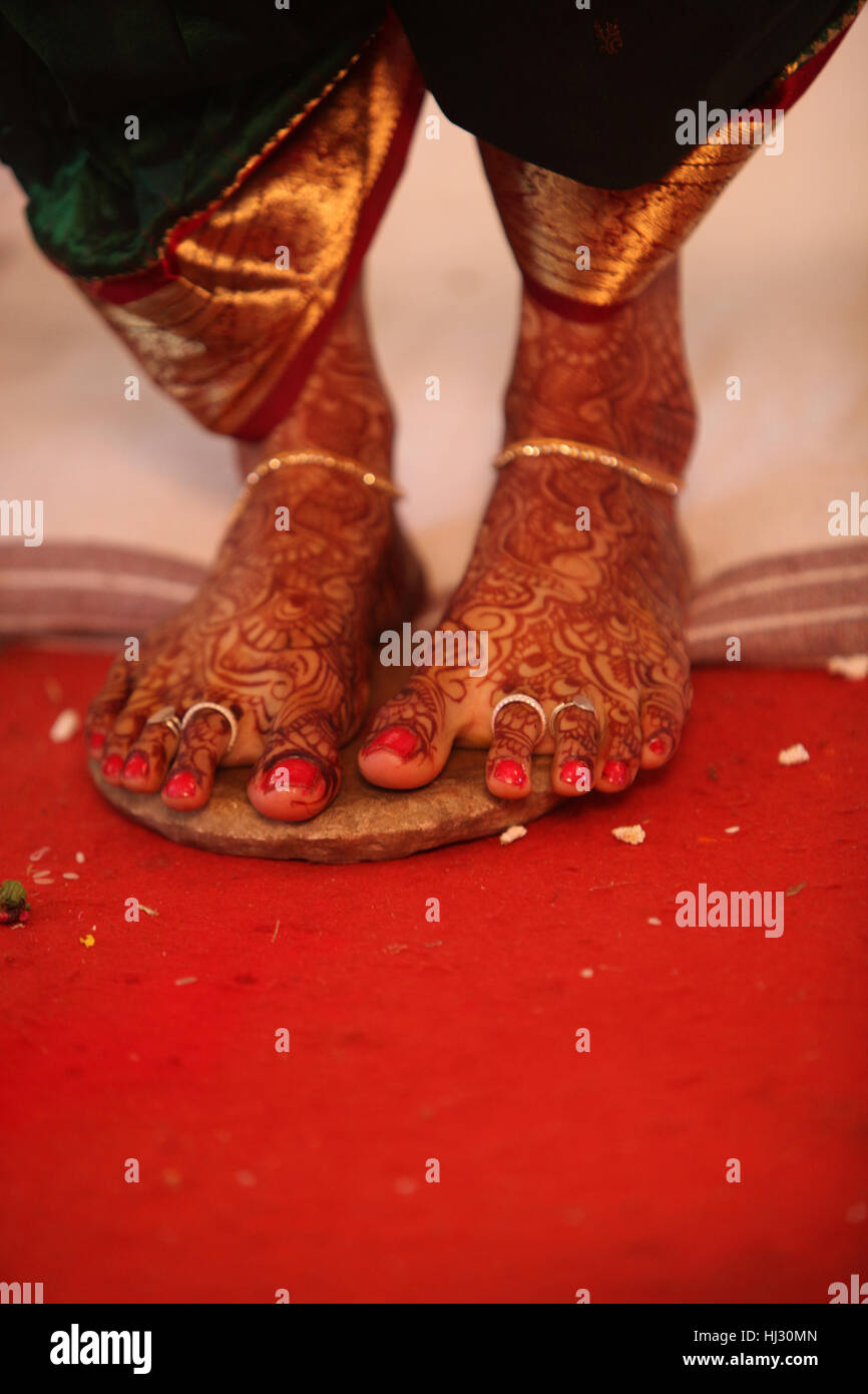 The feet of an Indian bride during the ritual in a traditional Hindu ...