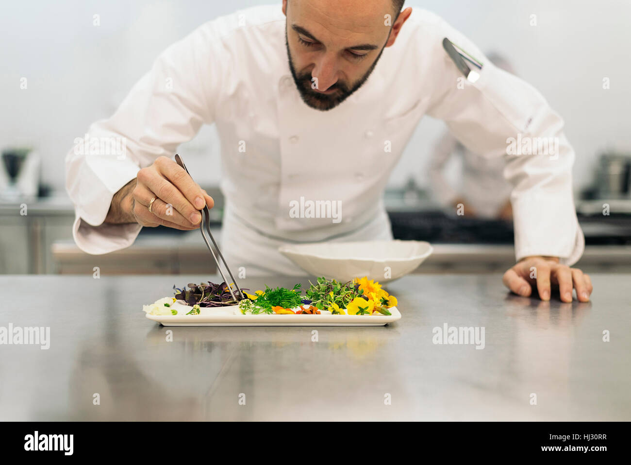 Male professional chef cooking in a kitchen Stock Photo - Alamy