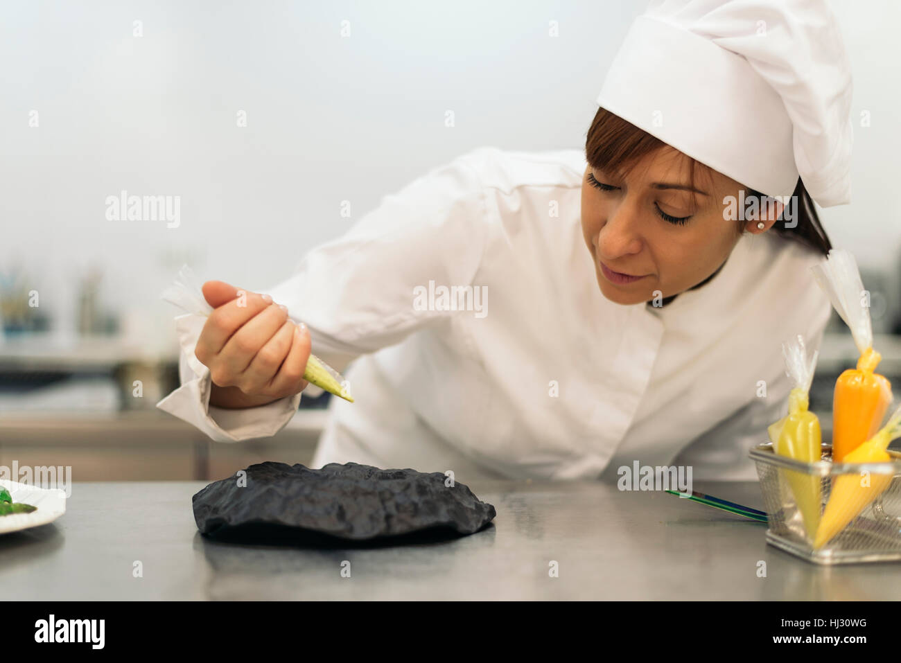 Pretty professional chef cooking in a kitchen.Cooking concept Stock ...