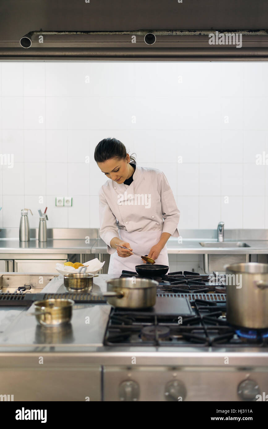 Pretty professional chef cooking in a kitchen.Cooking concept Stock ...