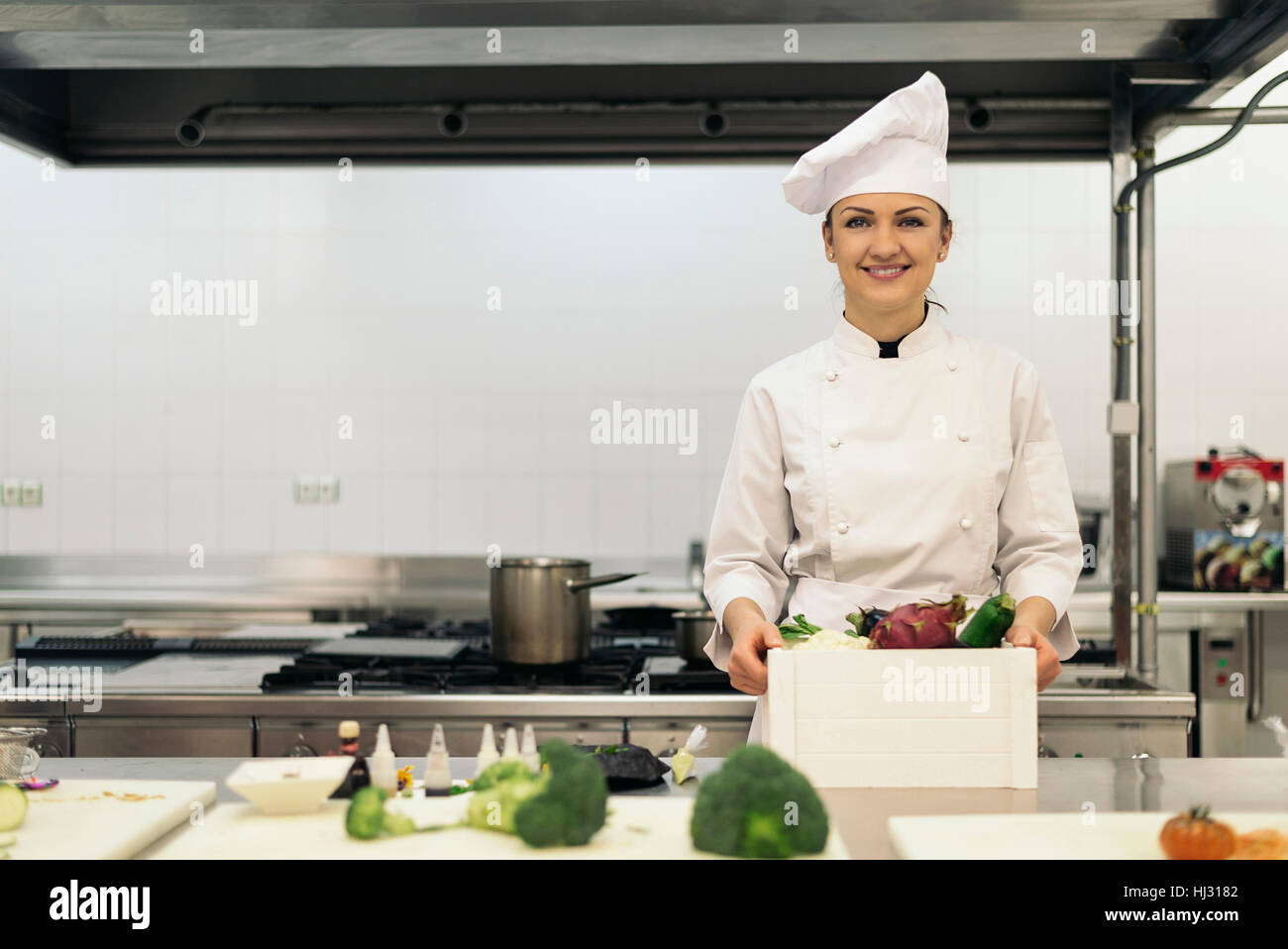 Pretty professional chef cooking in a kitchen Stock Photo - Alamy