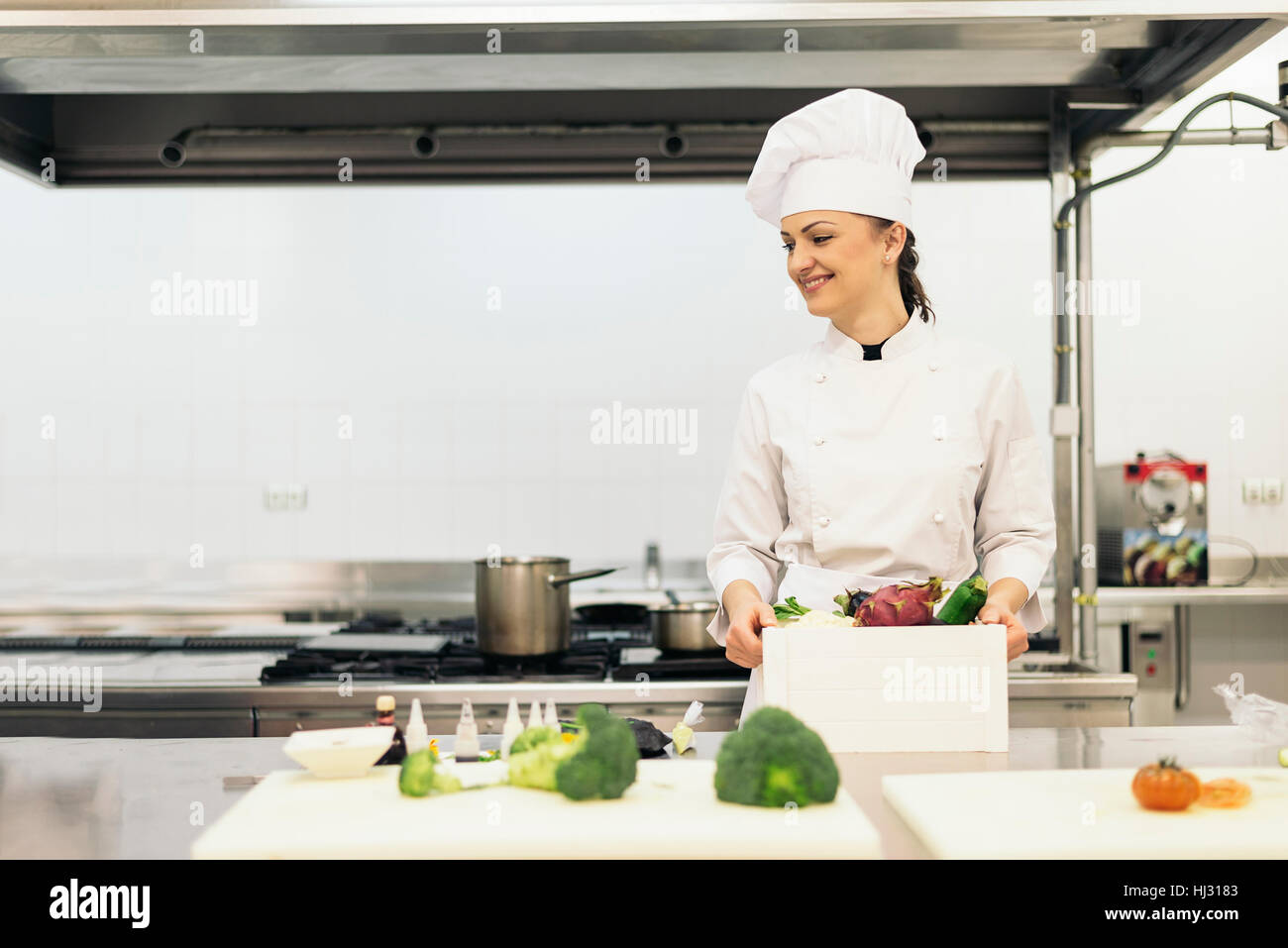 Pretty professional chef cooking in a kitchen Stock Photo - Alamy