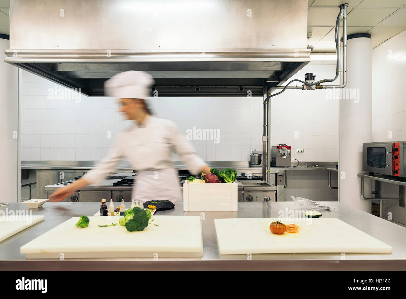 Pretty professional chef cooking in a kitchen Stock Photo - Alamy