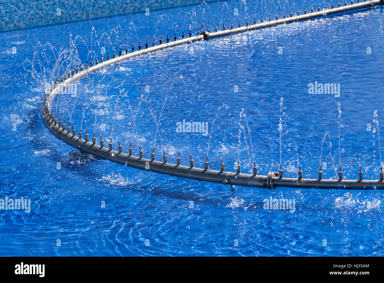 Blue fountain with sprinklers, note shallow depth of field Stock Photo ...