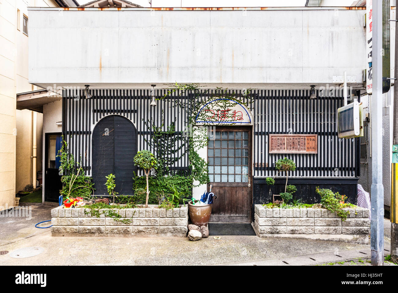 Japan, Shikoku, Ozu. Traditional front of small cafe with black wooden ...
