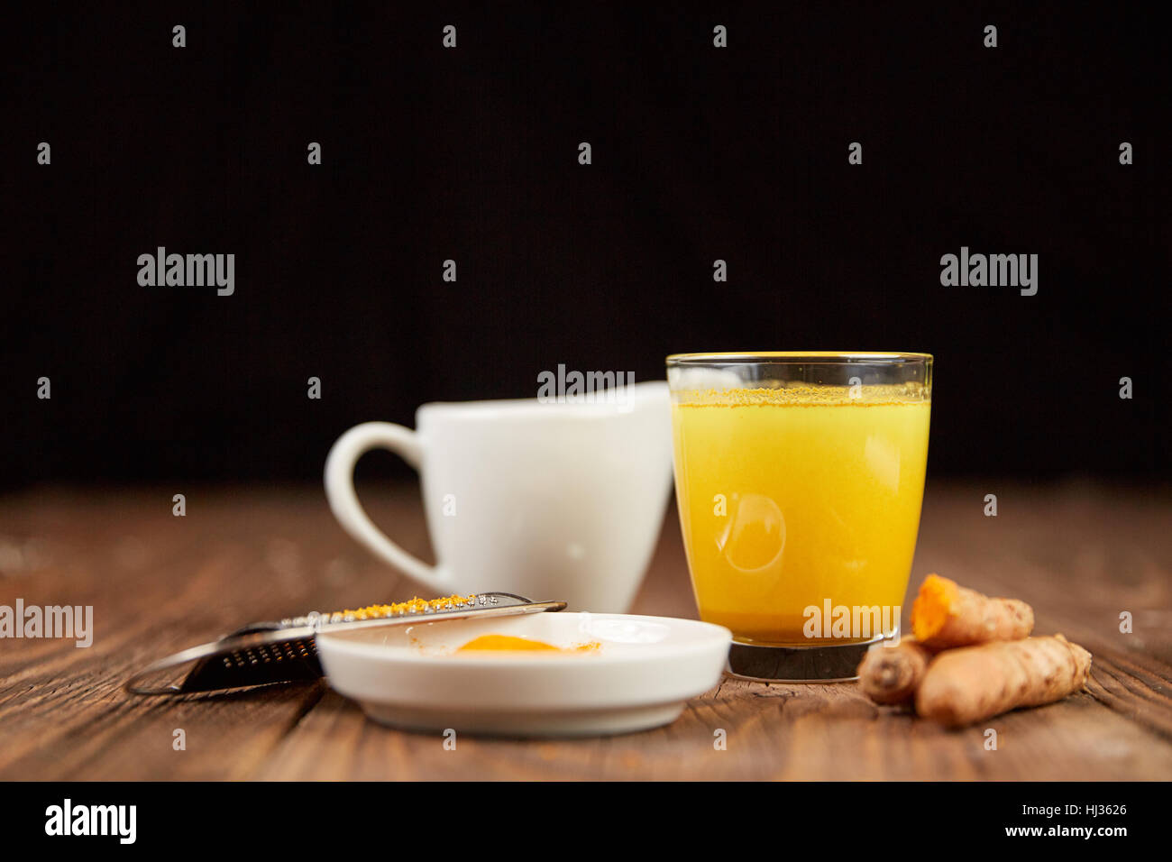 Golden milk turmeric tea with curcuma root and orange powder Stock ...