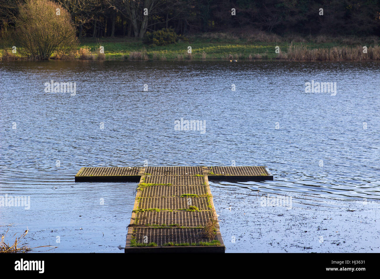 Small fishing platform at a reservoir used by anglers for fishing trout ...