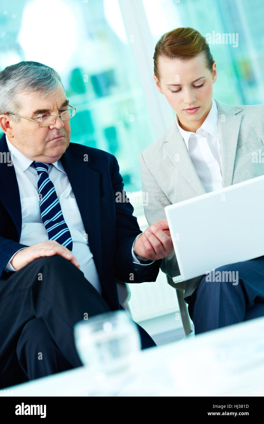 Colleagues senior woman computer point hi-res stock photography and ...
