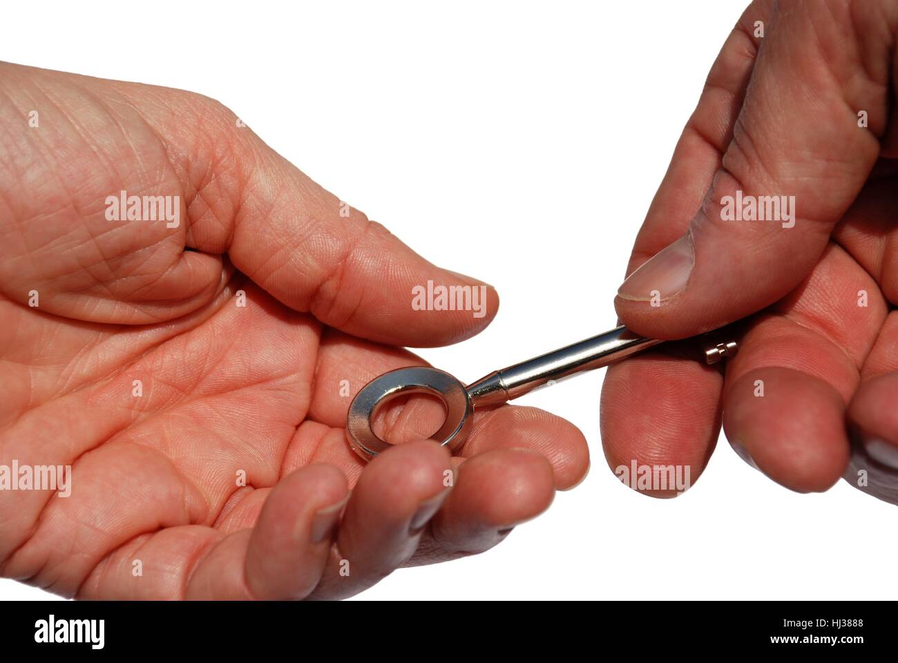 closeup of two hands reaching a key Stock Photo - Alamy