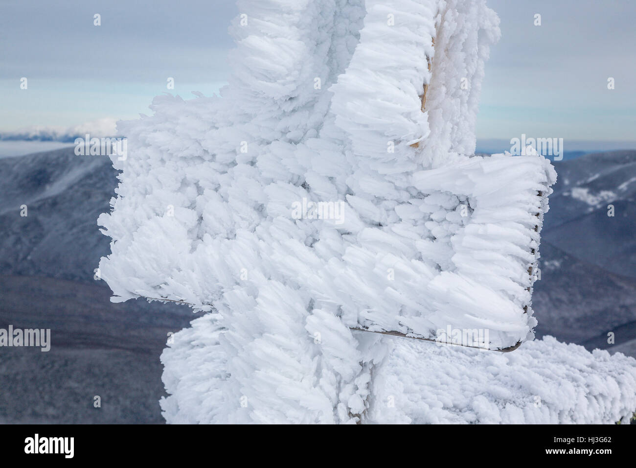 Trail sign on the summit of Mount Lafayette covered in snow during the ...