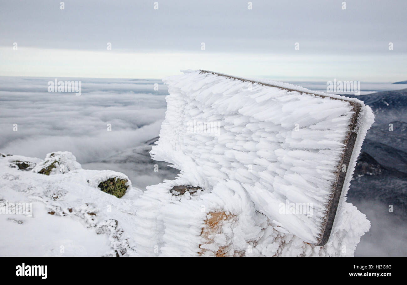 Trail sign on the summit of Mount Lafayette covered in snow during the ...