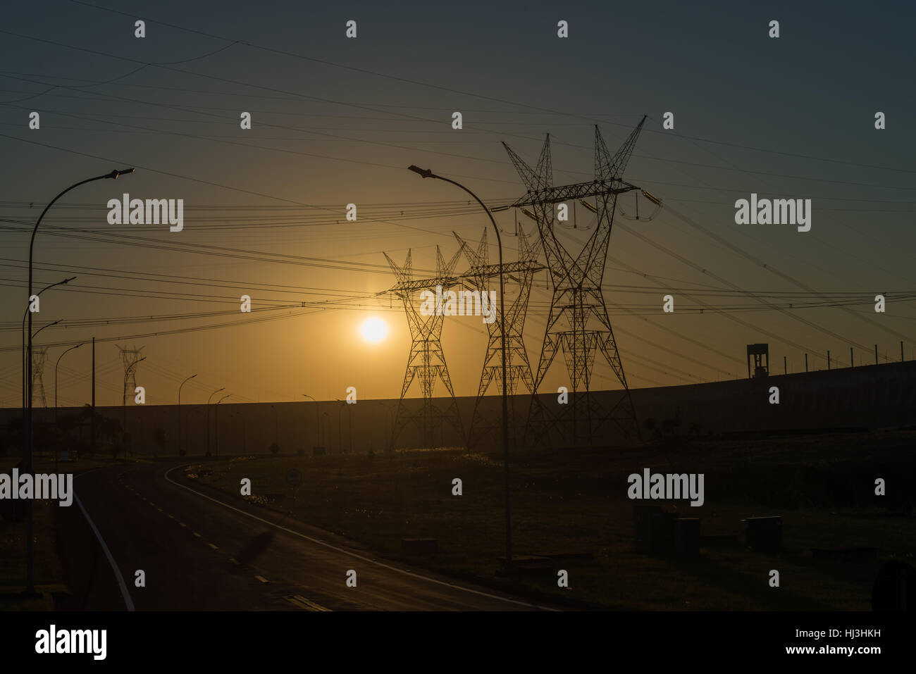 Power lines at the sunset near Itaipu dam located on river Parana which ...