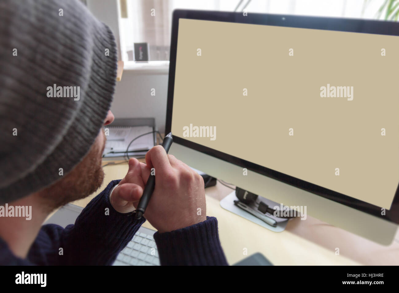 Creative man staring at computer screen thinking Stock Photo - Alamy