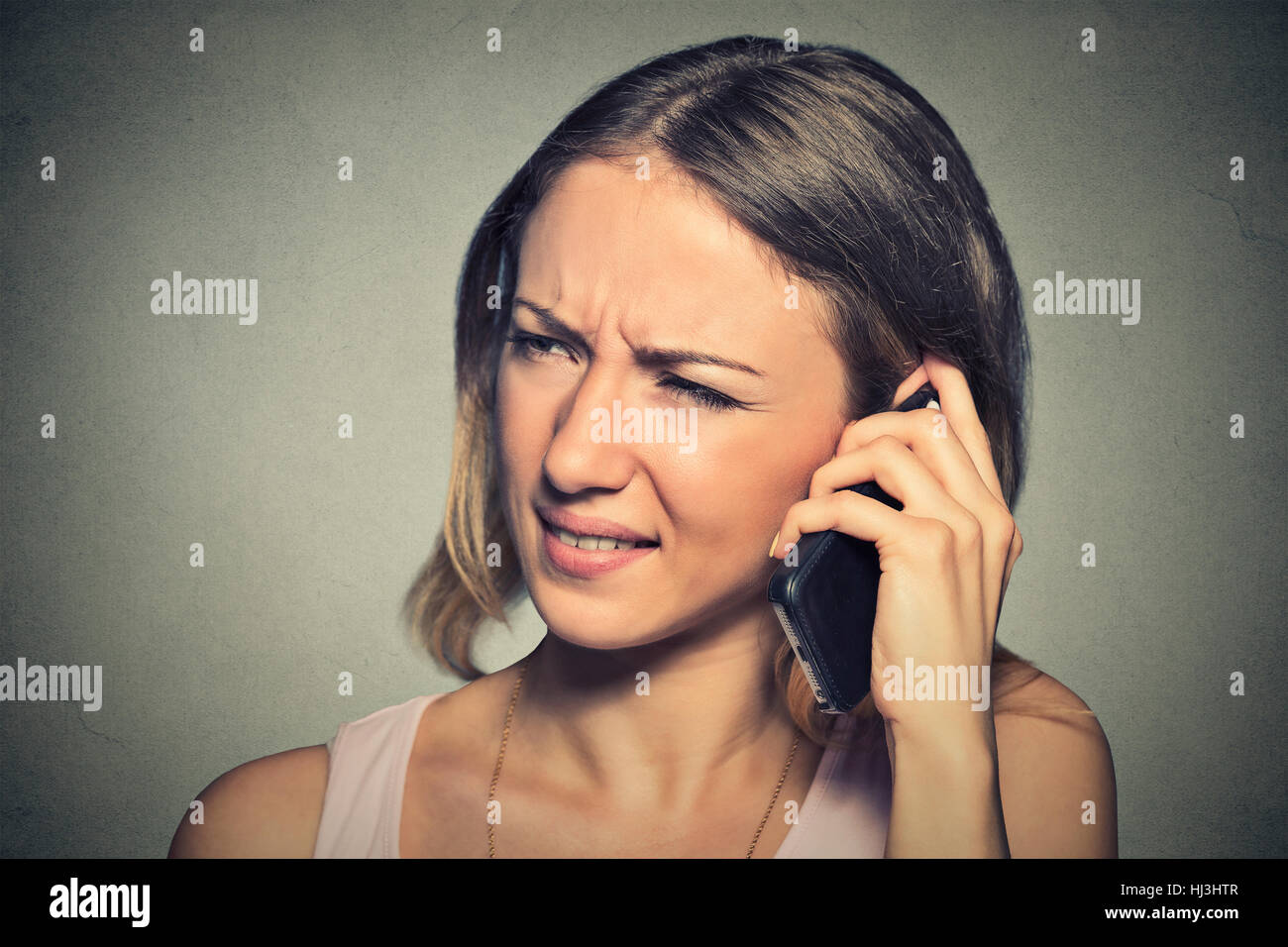 Portrait upset sad annoyed unhappy woman talking on cell phone ...