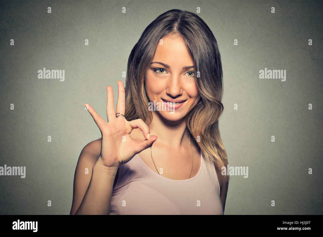 Portrait beautiful happy young woman showing Ok sign with hand isolated ...