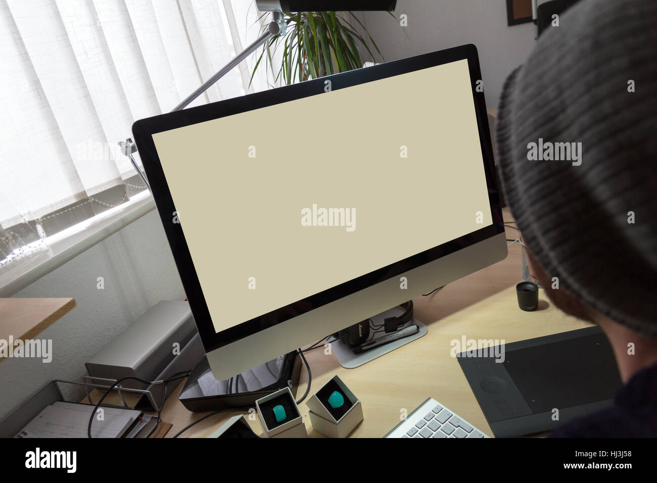 Large blank desktop screen sat on corner desk in a modern creative ...