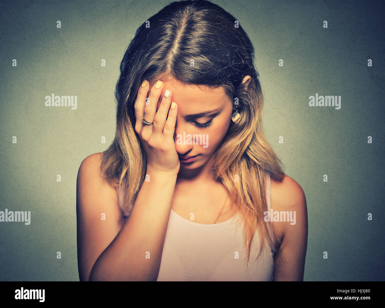 problems. Sad woman isolated on gray wall background Stock Photo - Alamy