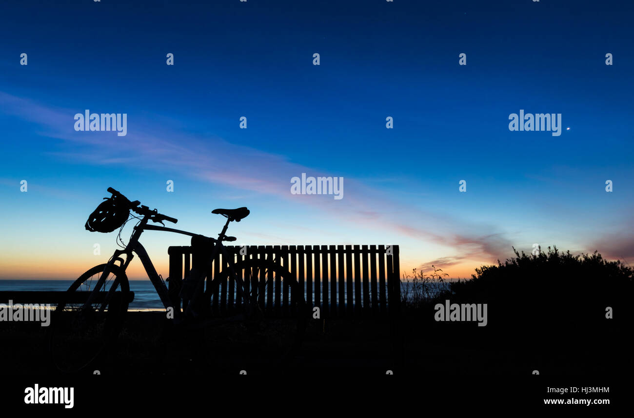 A cycle and a beach side seat with the first night sky star out Stock ...