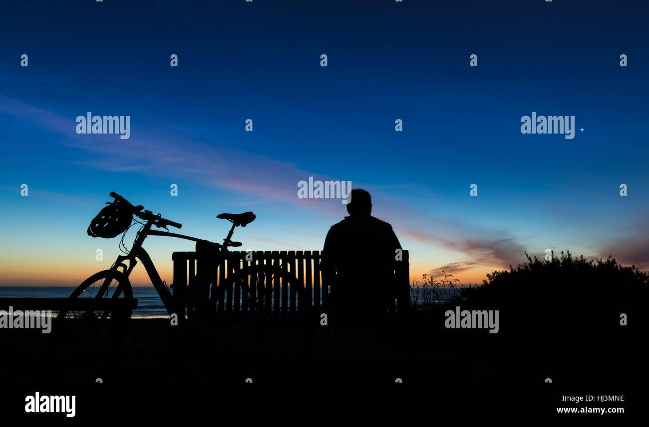 A Man siting on a beach side seat watch the first night sky star Stock ...