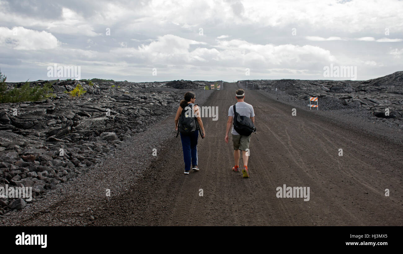 Hikers on trail through a lava field, Kalapana, Hawaii, USA Stock Photo ...