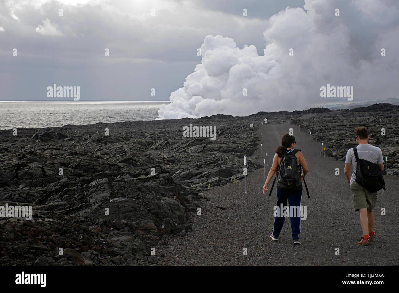 Hikers on trail through a lava field, Kalapana, Hawaii, USA Stock Photo ...